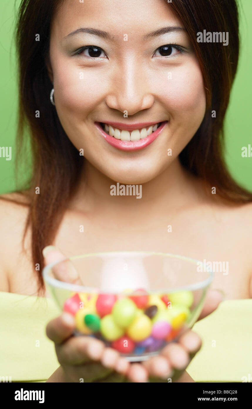 Woman holding candy and candy bowl hi-res stock photography and images ...