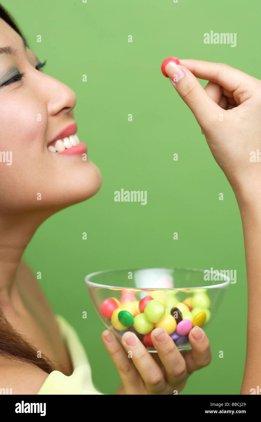 Young woman eating piece candy hi-res stock photography and images - Alamy