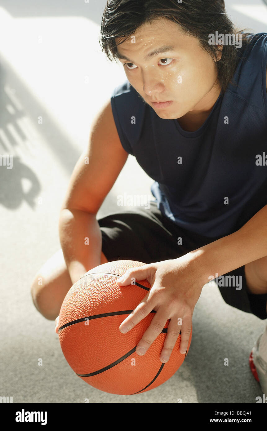 High angle view portrait of young man crouching hi-res stock ...