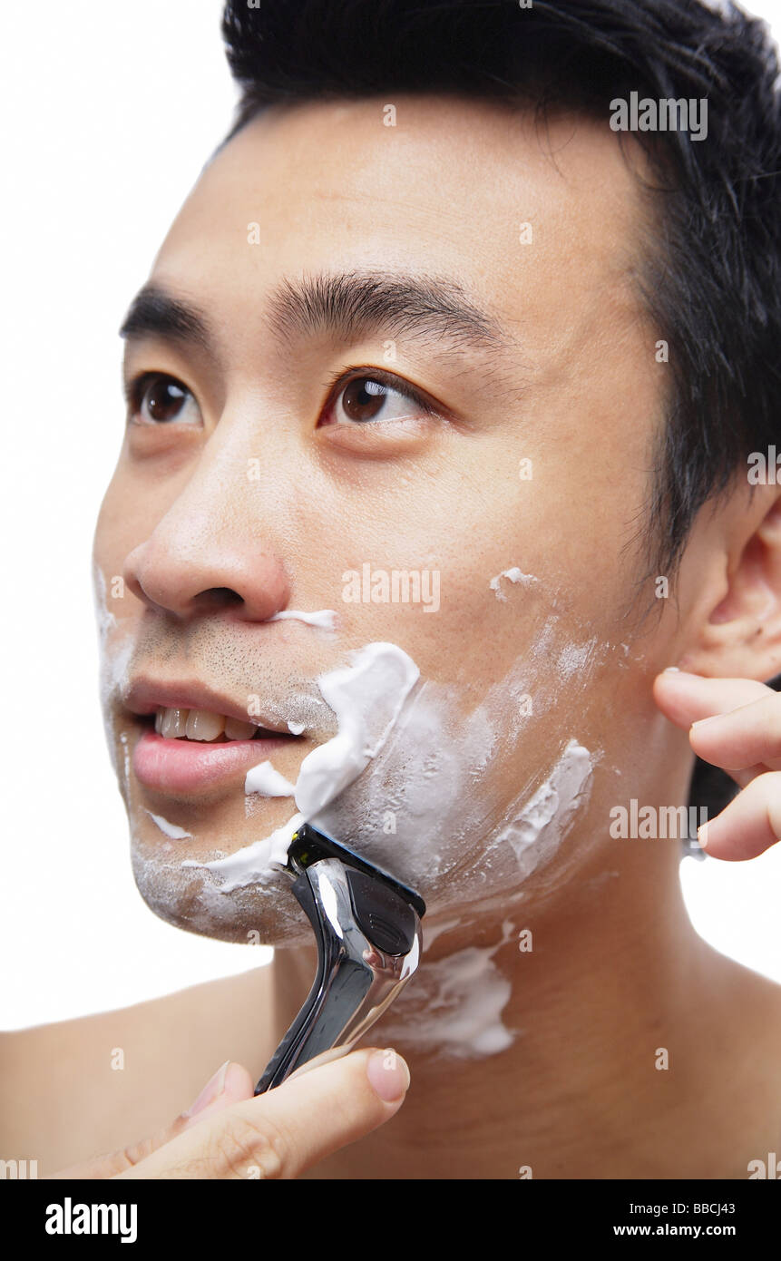 Man shaving face Stock Photo - Alamy