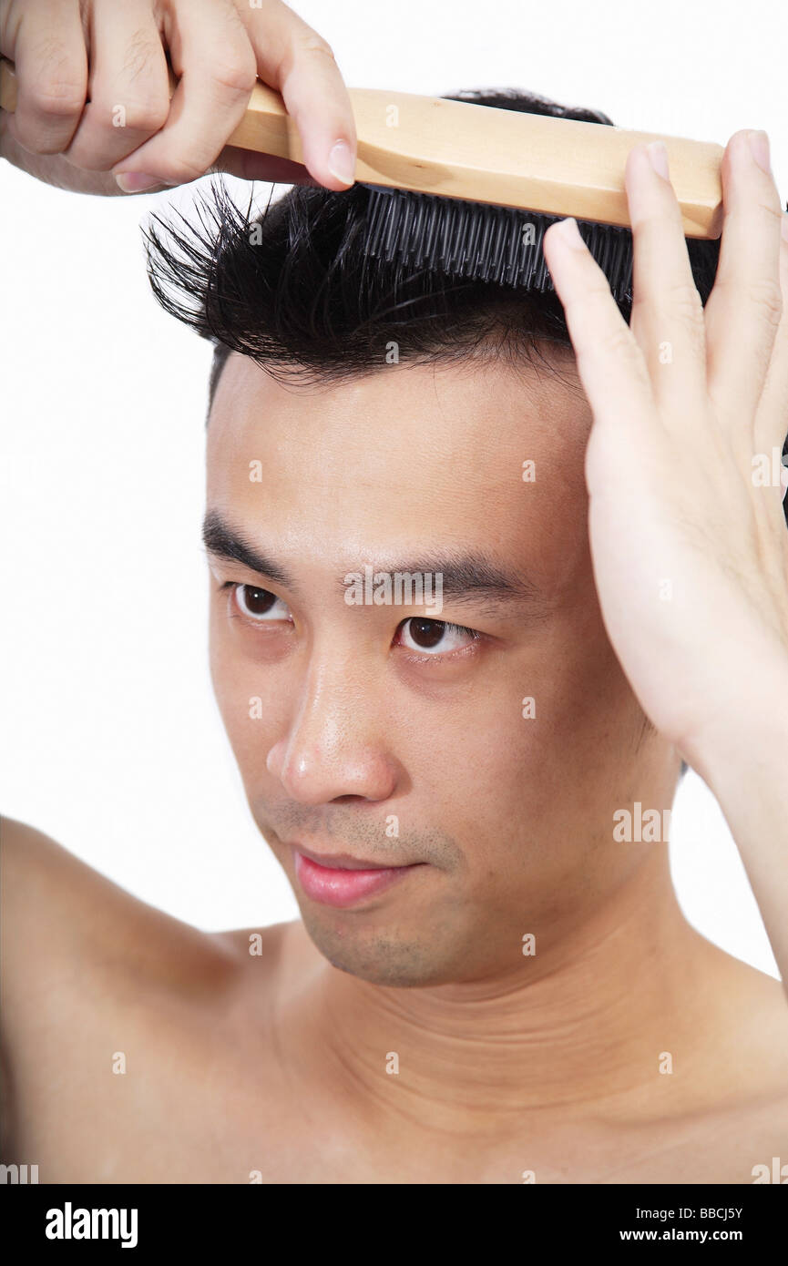 Man brushing hair Stock Photo - Alamy