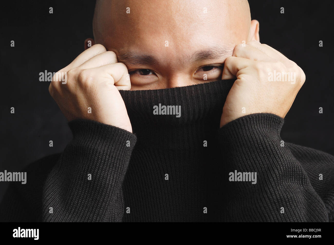 Man hiding behind turtleneck hi-res stock photography and images - Alamy