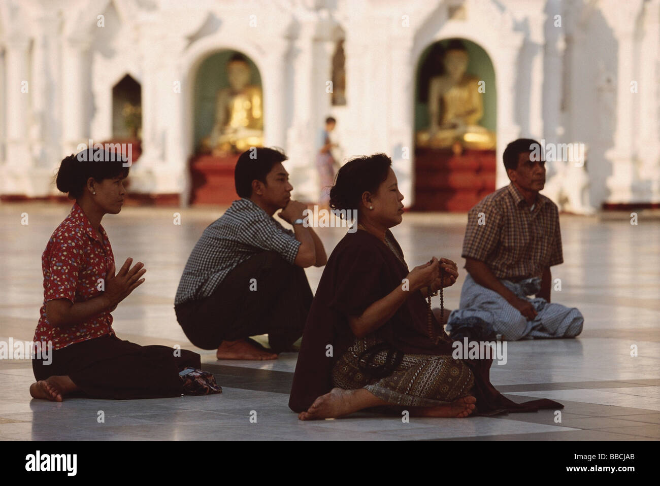 Myanmar (Burma), Yangon, Worshippers praying at Shwedagon Paya Stock ...