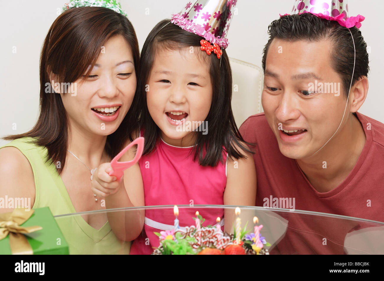 Family with one child celebrating a birthday Stock Photo - Alamy