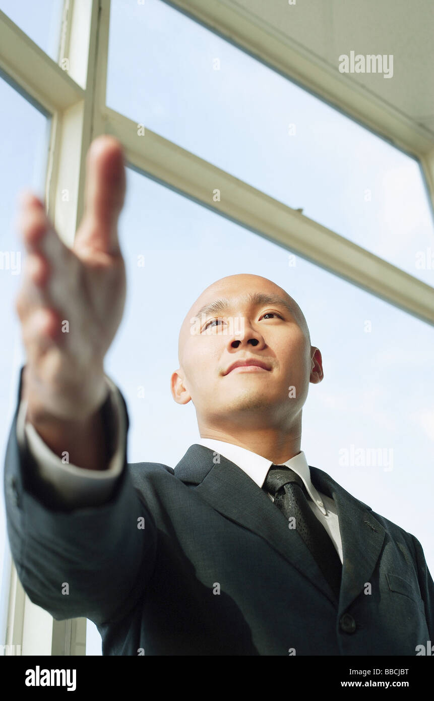 Businessman, hand outstretched Stock Photo - Alamy