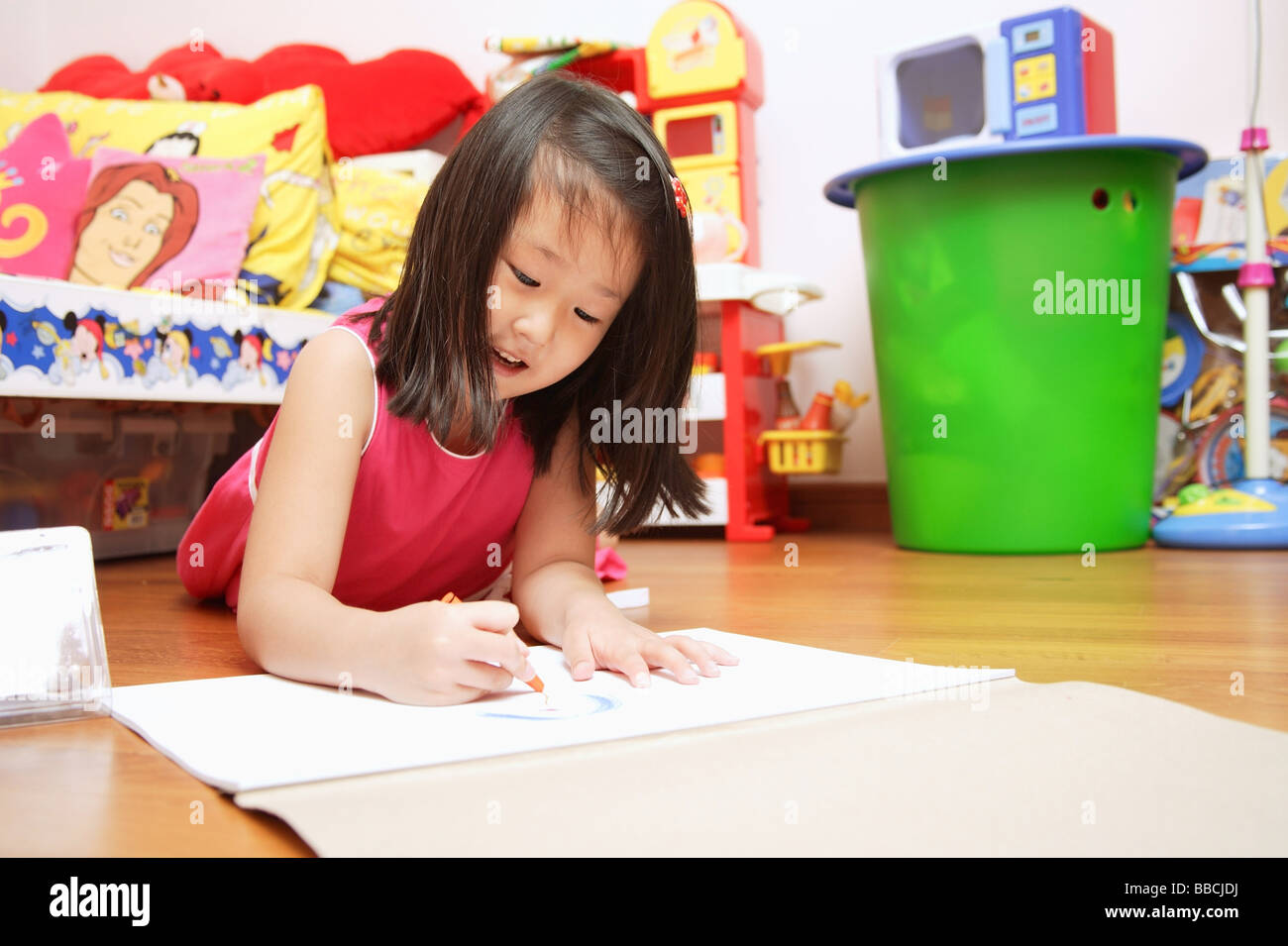 Young girl on floor, drawing on paper Stock Photo - Alamy