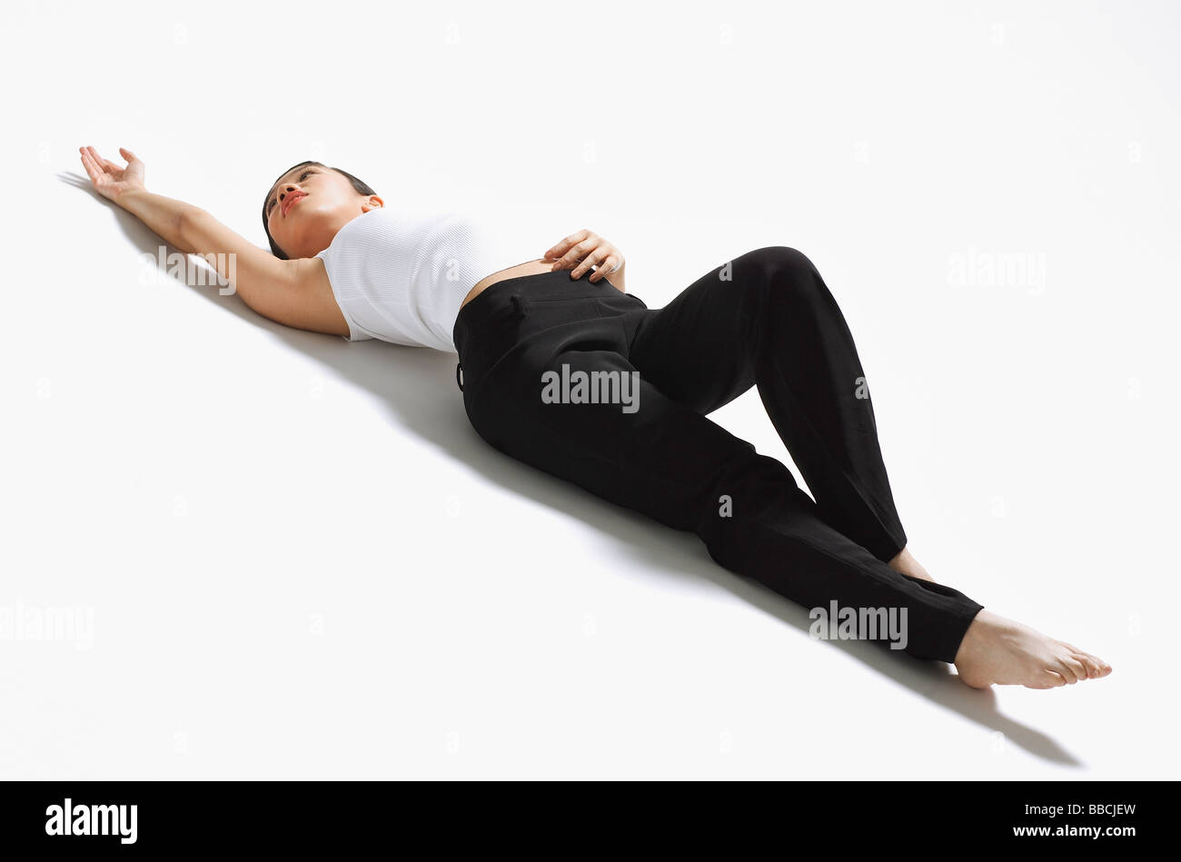Woman lying on back, stretching Stock Photo - Alamy