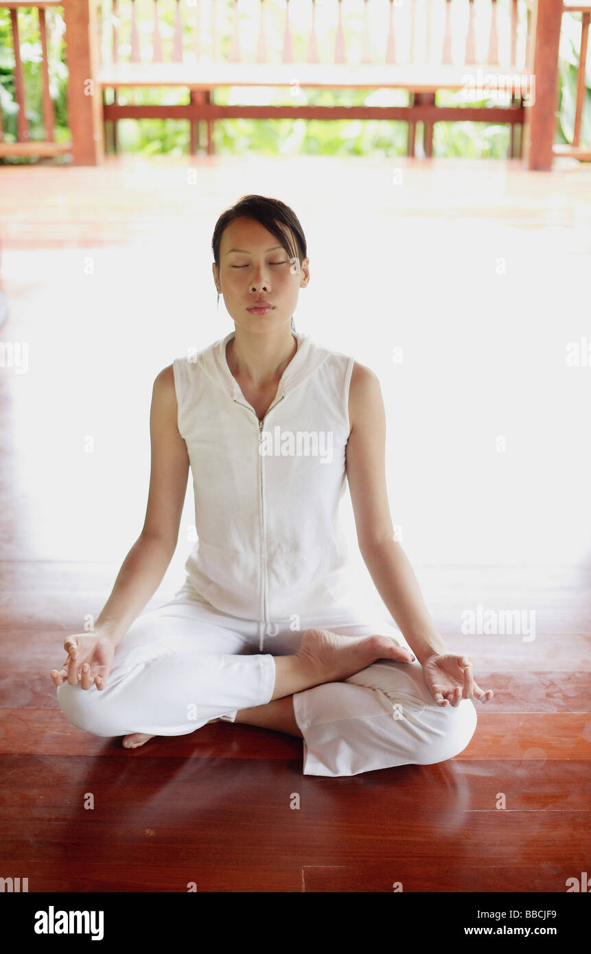 Woman sitting in lotus position Stock Photo - Alamy