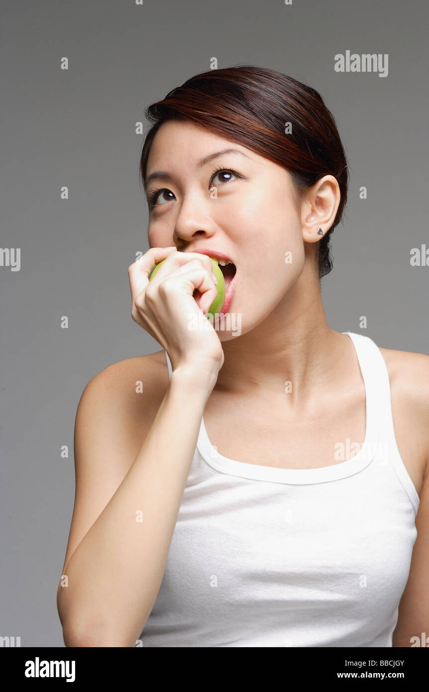 Woman biting into apple Stock Photo - Alamy