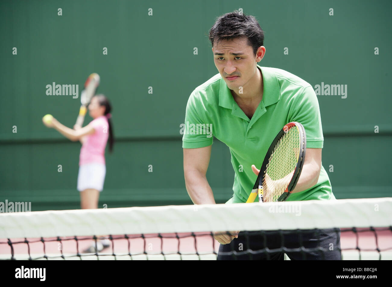 Man standing behind tennis hi-res stock photography and images - Alamy