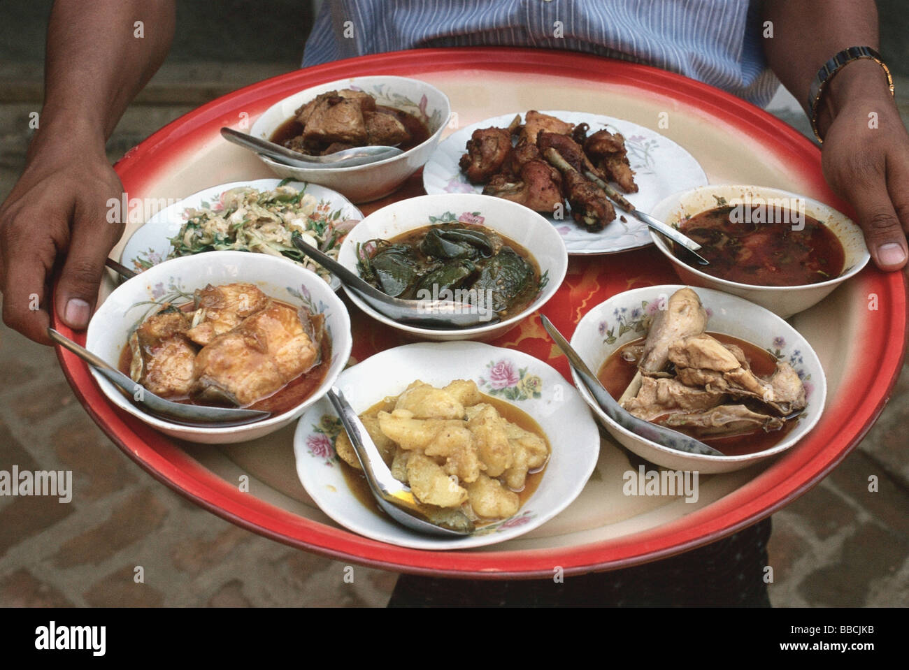 Myanmar (Burma), New Bagan, Selection of Burmese food on tray held by ...