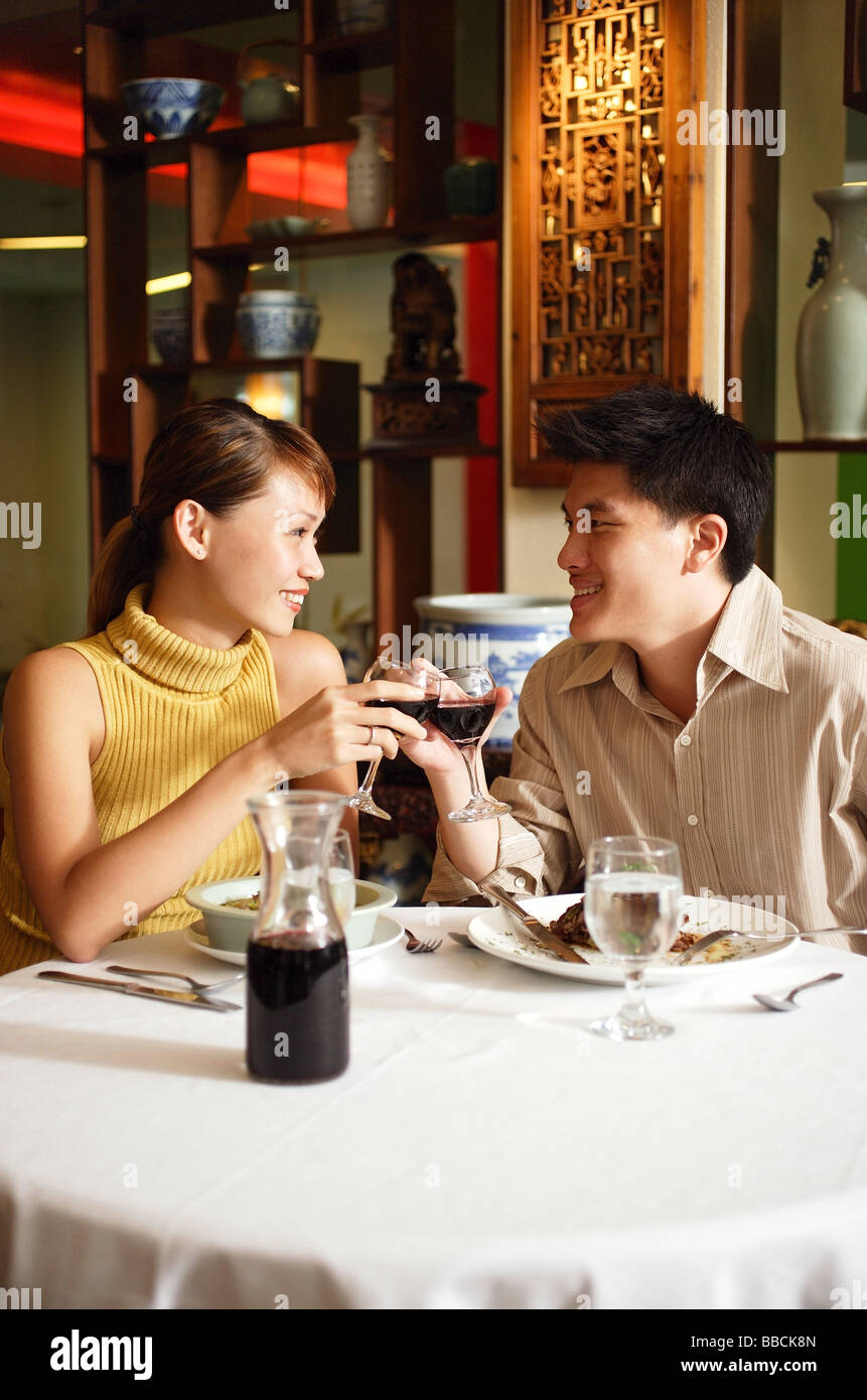 Couple toasting with wine glasses in Chinese restaurant Stock Photo - Alamy
