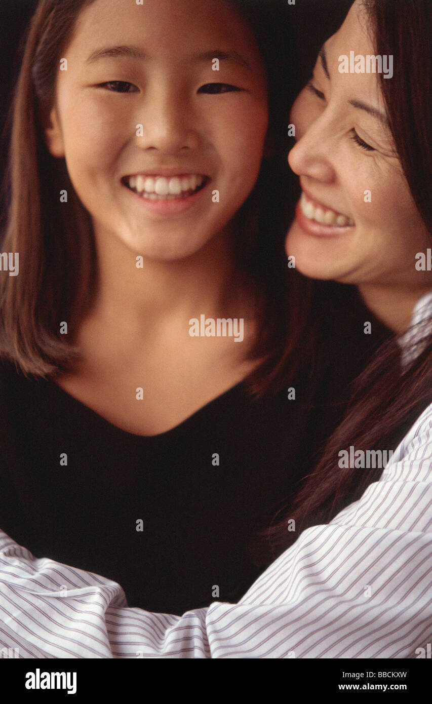 Mother and daughter hugging and smiling Stock Photo - Alamy
