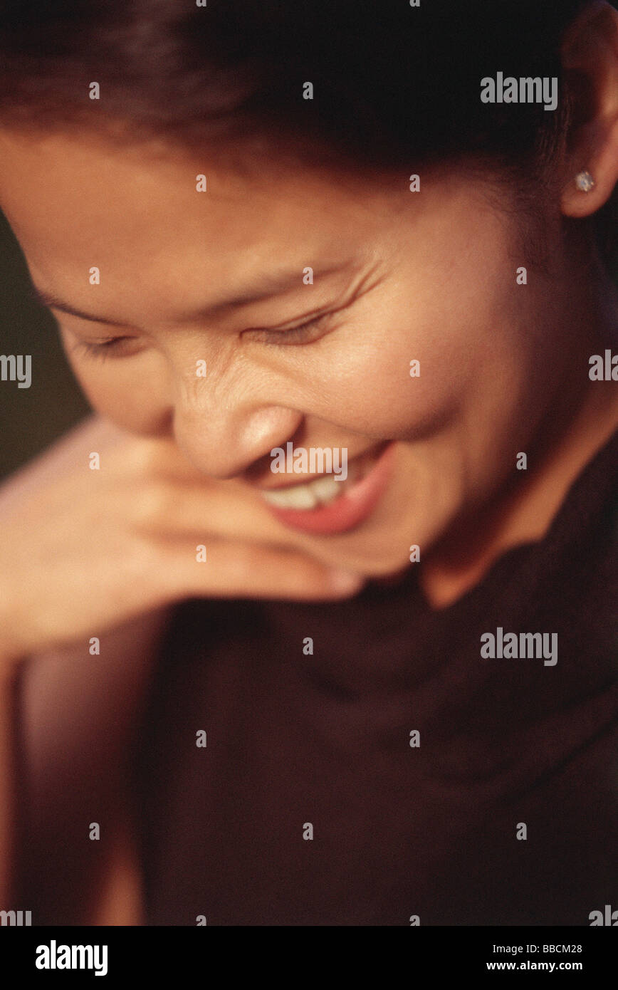 Woman looking down and smiling Stock Photo - Alamy