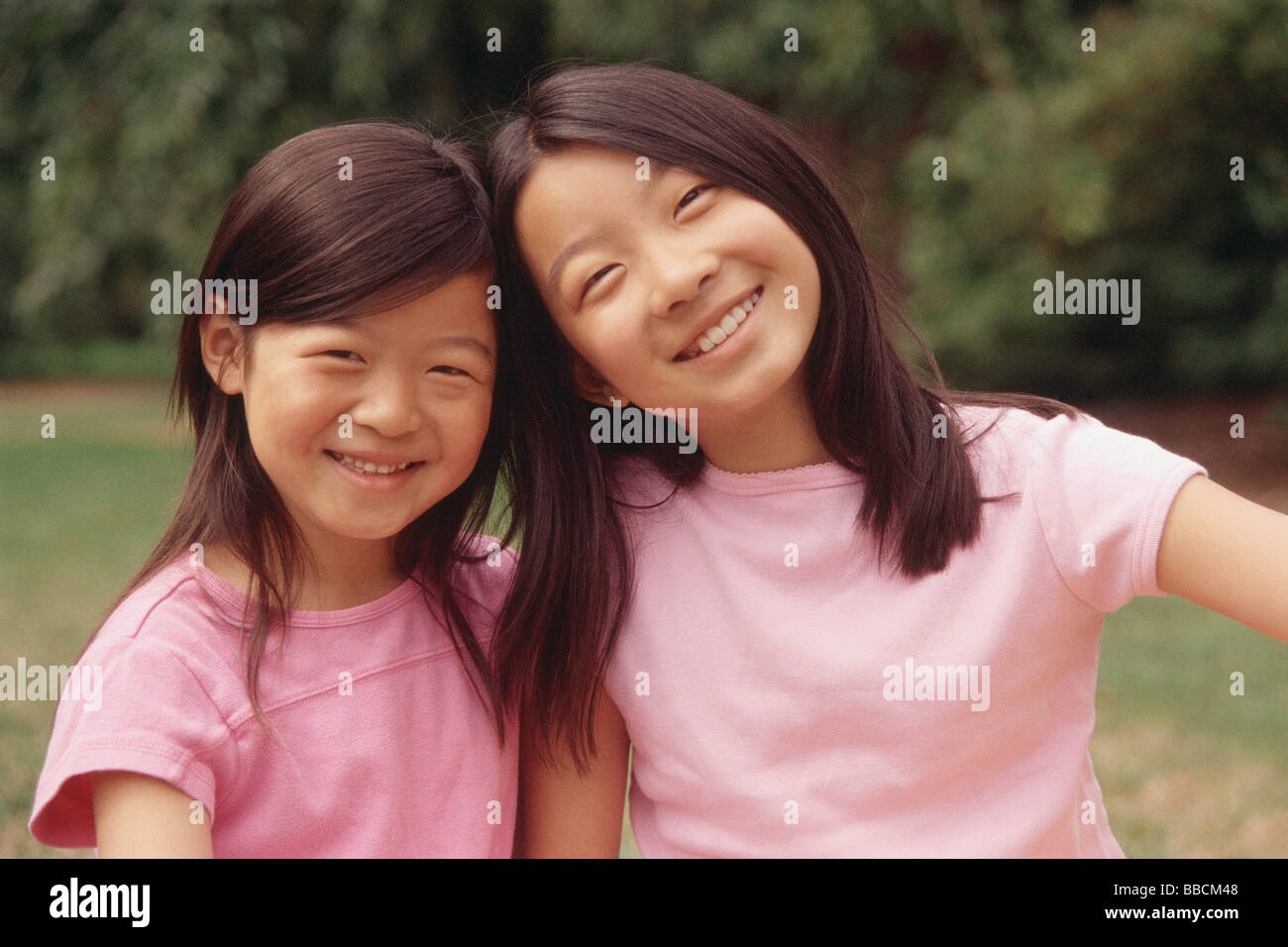 Two sisters smiling, portrait Stock Photo - Alamy