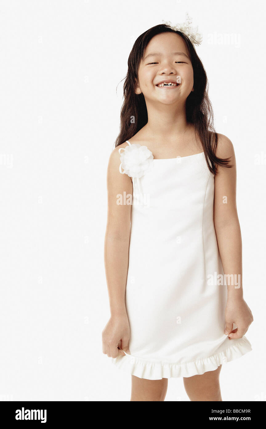 Girl in white dress, smiling Stock Photo - Alamy