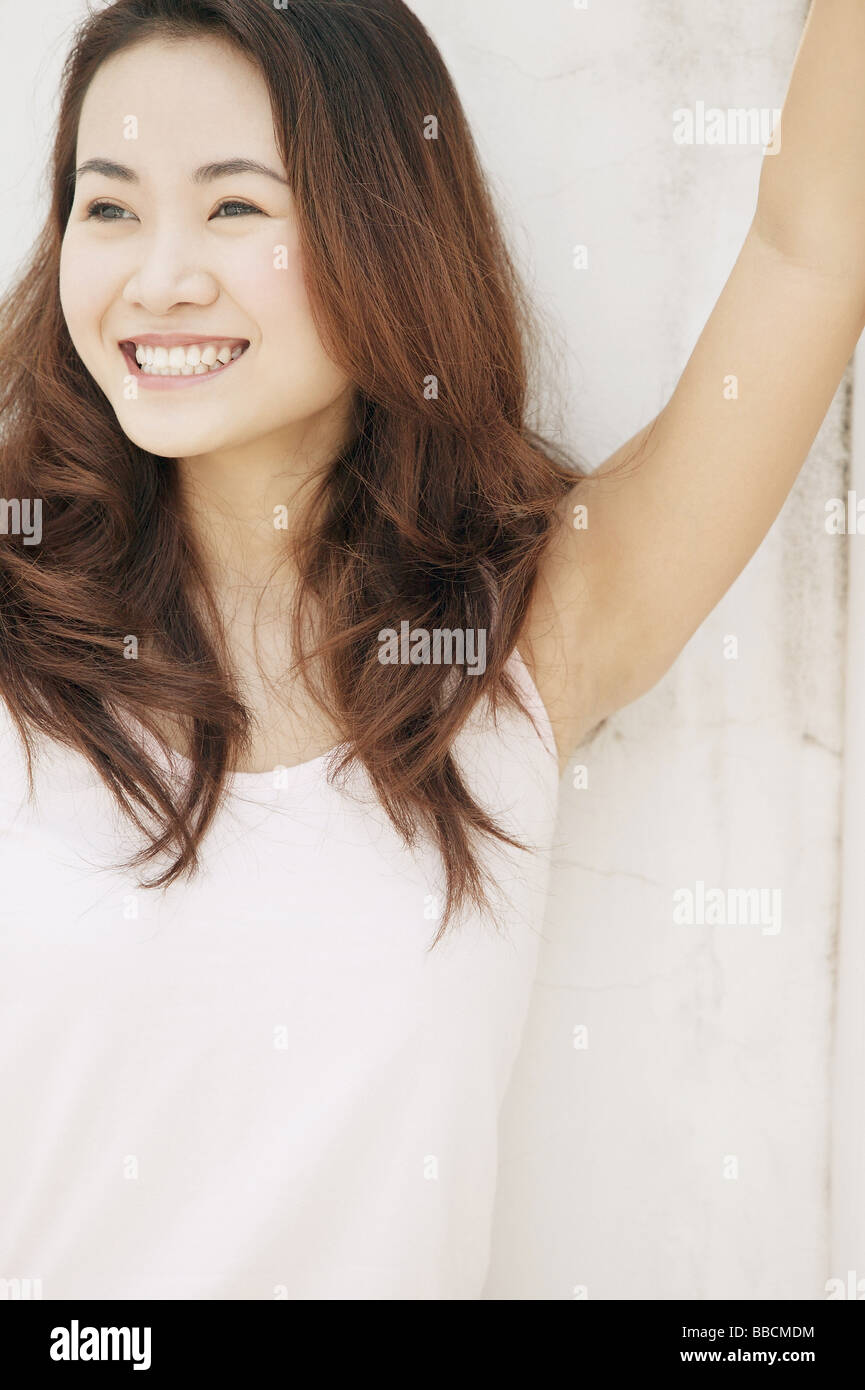 Young woman standing with arm outstretched Stock Photo - Alamy