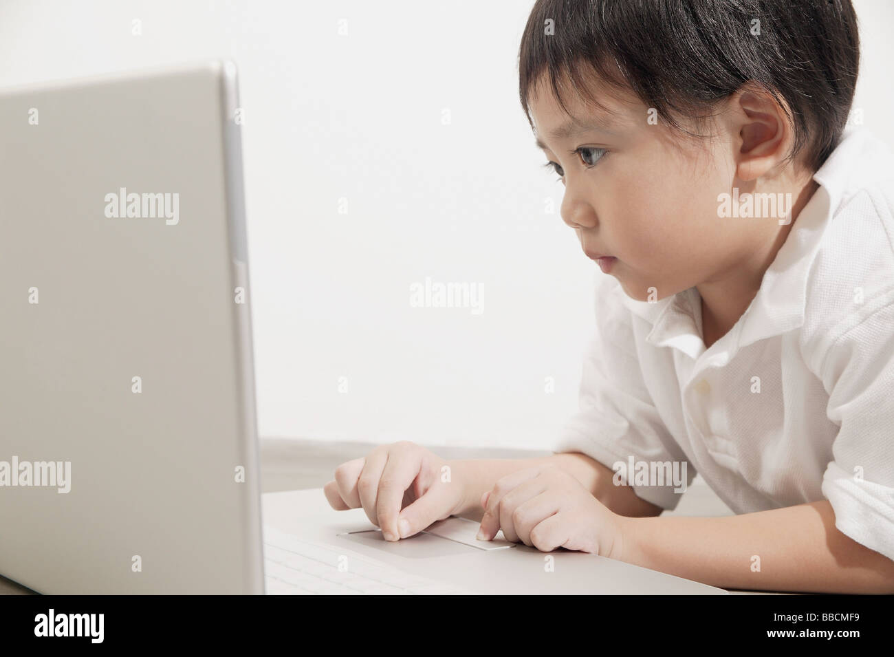 Young boy using laptop Stock Photo - Alamy