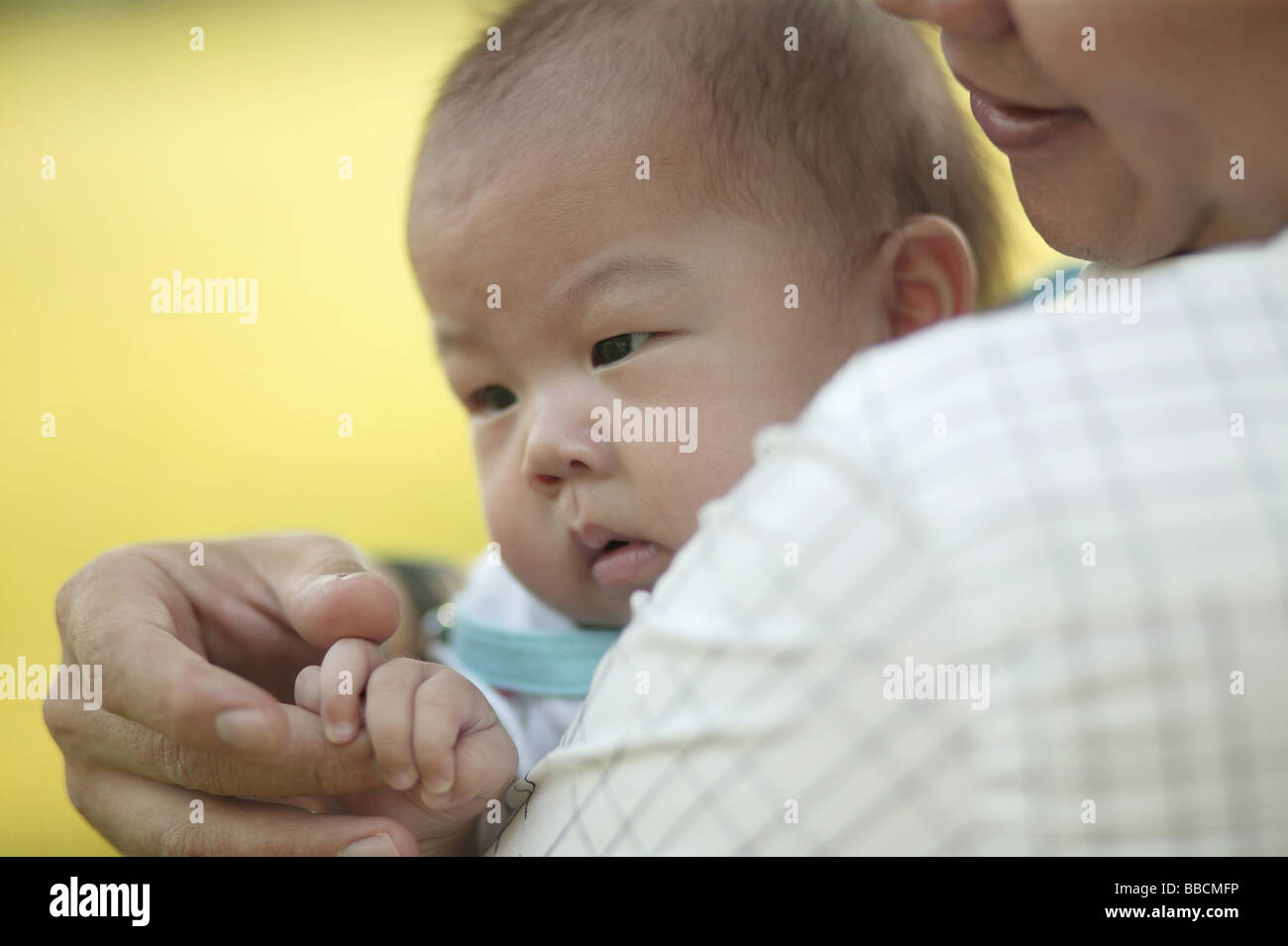 Baby with hands over head touching hi-res stock photography and images ...