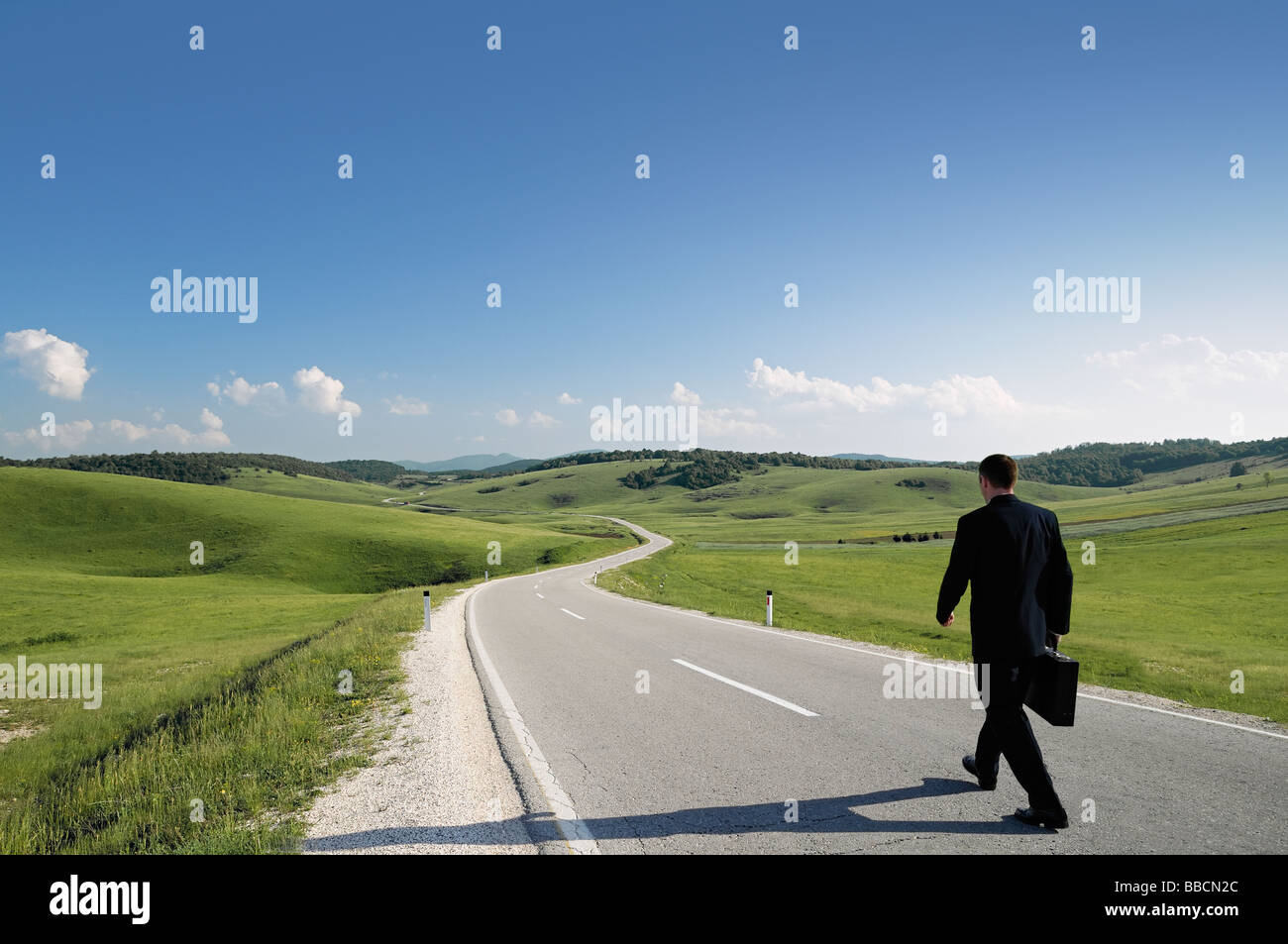 Businessman Walking Along an Isolated Country Road Rear View Stock ...