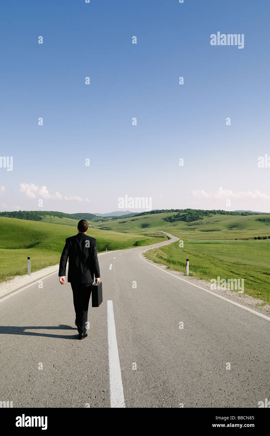 Businessman Walking Along an Isolated Country Road Rear View Stock ...