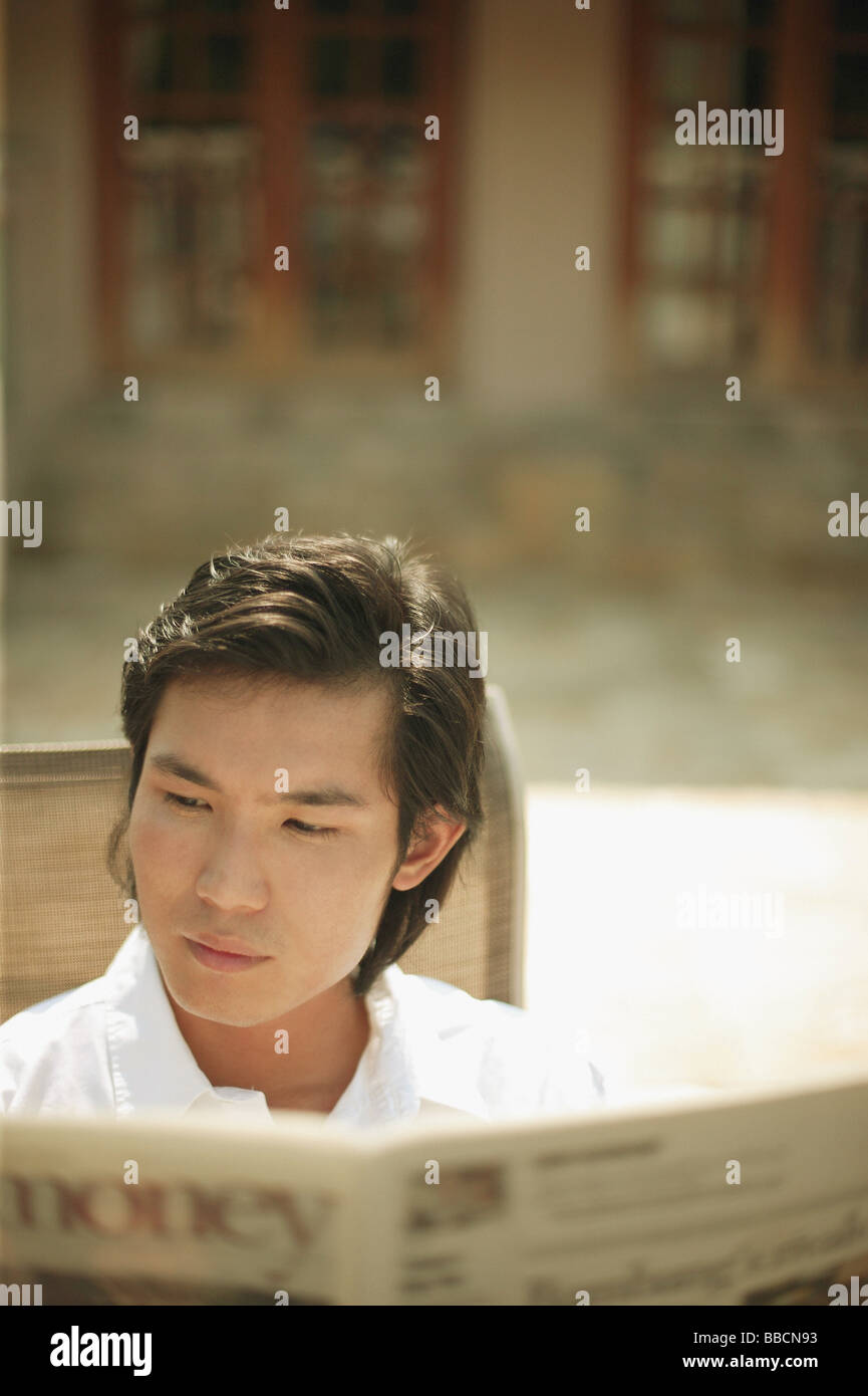 Young man reading newspaper Stock Photo - Alamy Young man reading newspaper Stock Photo - Alamy