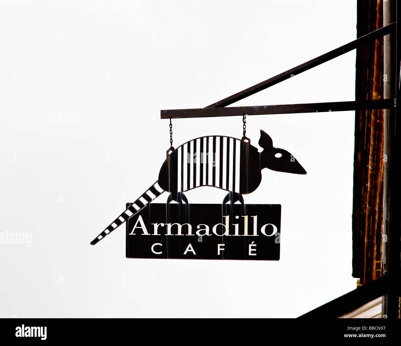Wrought iron hanging sign for a cafe in the shape of an armadillo Stock ...