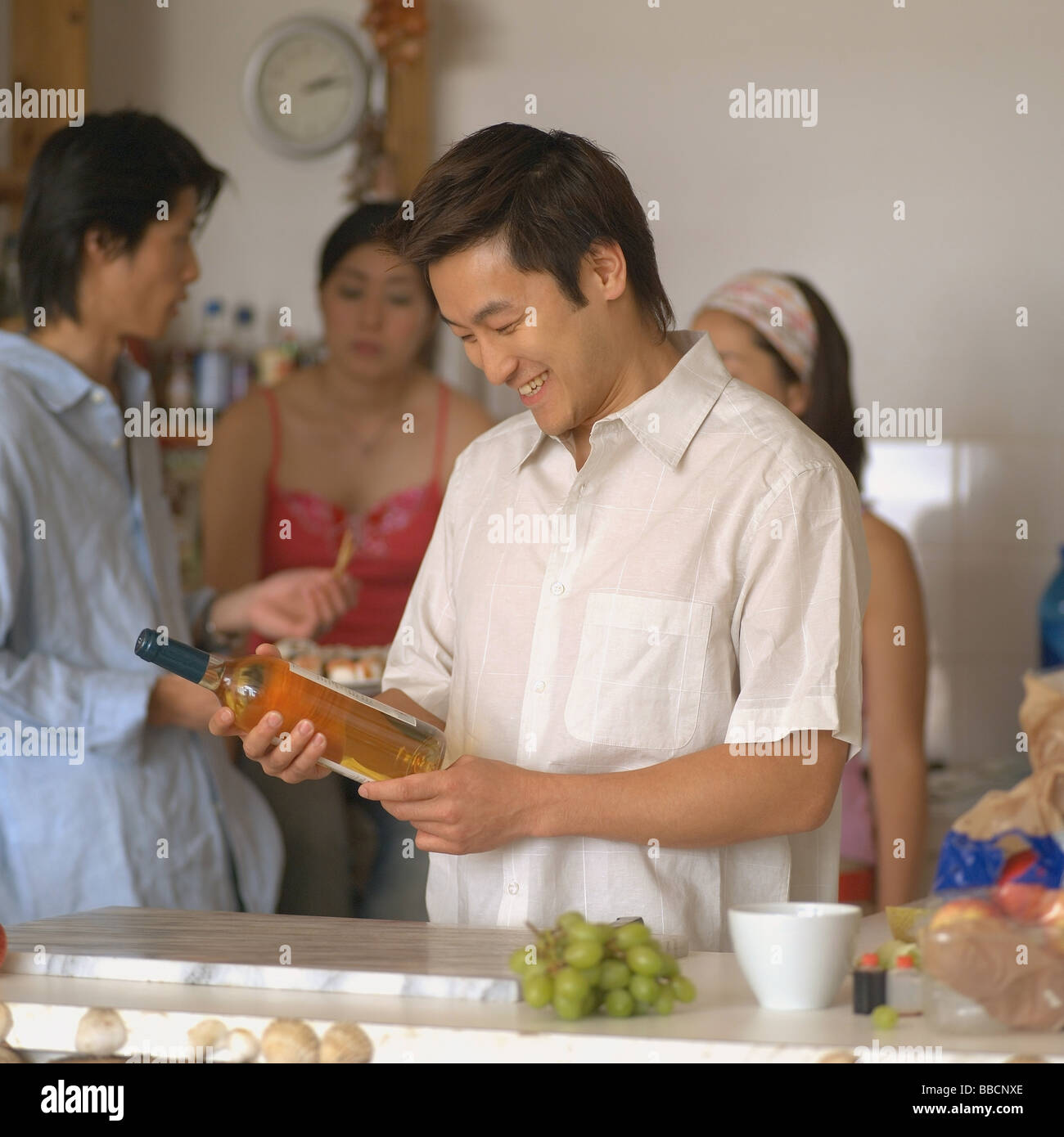 Friends in the kitchen, talking Stock Photo - Alamy
