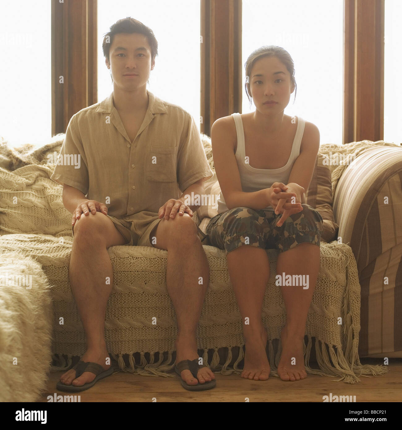 Couple sitting apart, home interior Stock Photo - Alamy