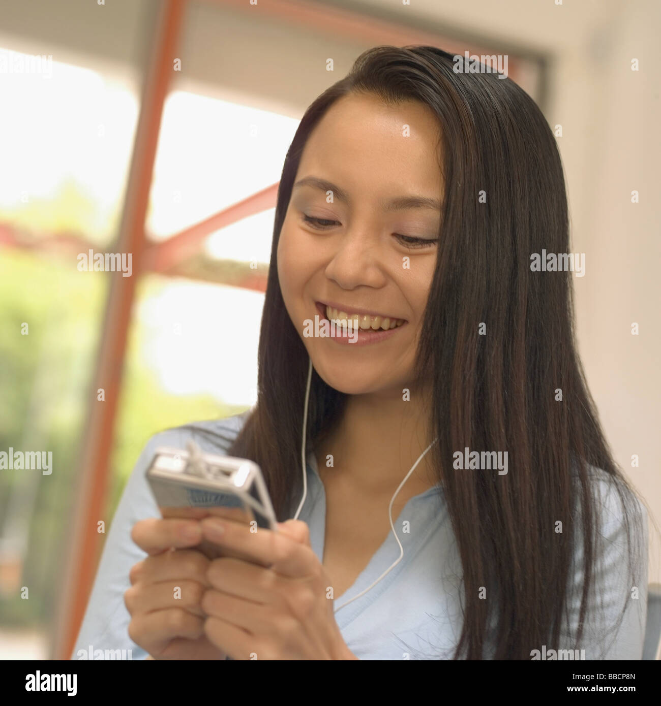 Young woman listening to personal stereo Stock Photo - Alamy