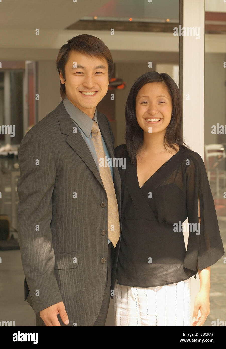 Couple side by side, looking at camera, smiling Stock Photo - Alamy
