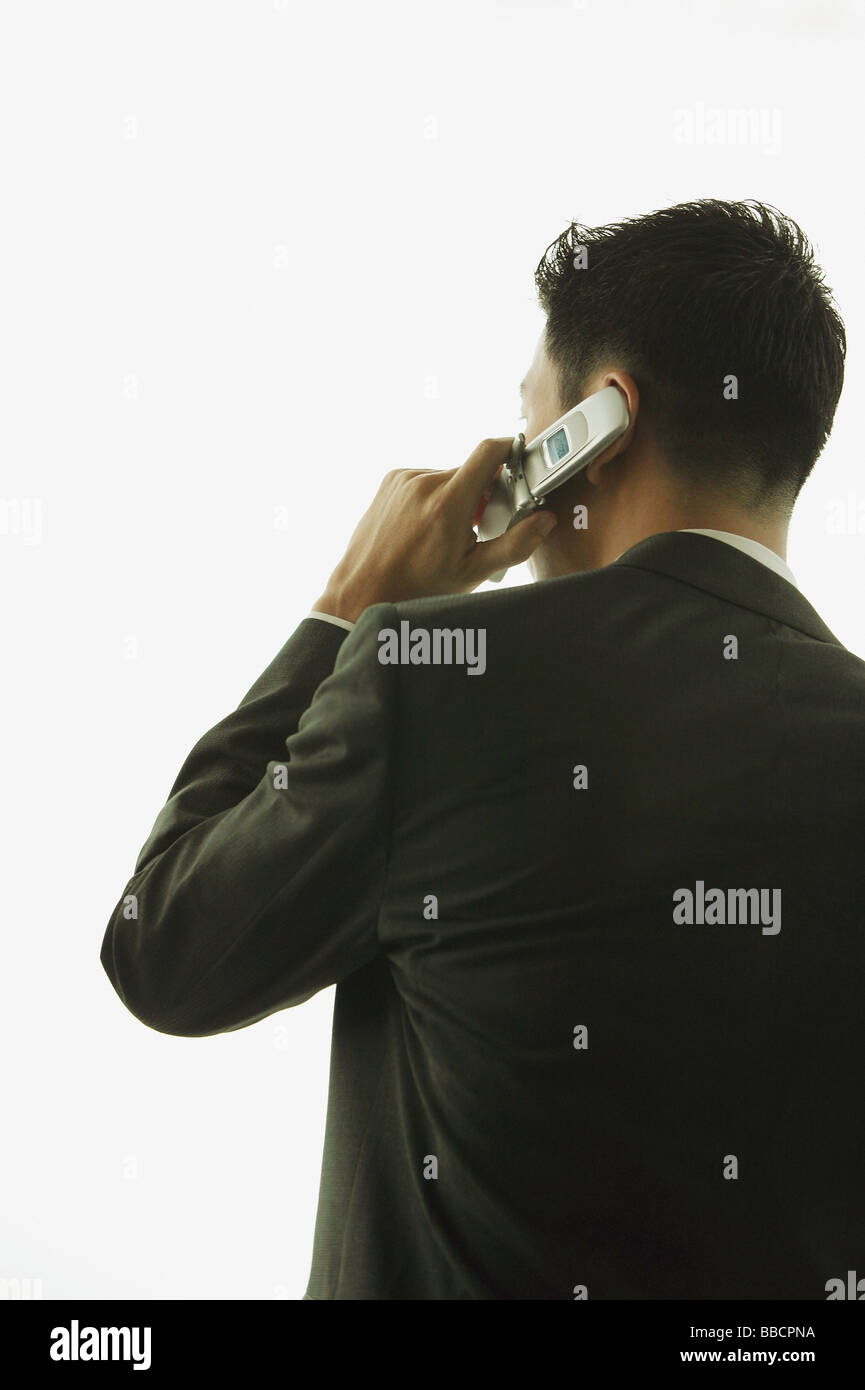 Young man, rear view, using mobile phone Stock Photo - Alamy