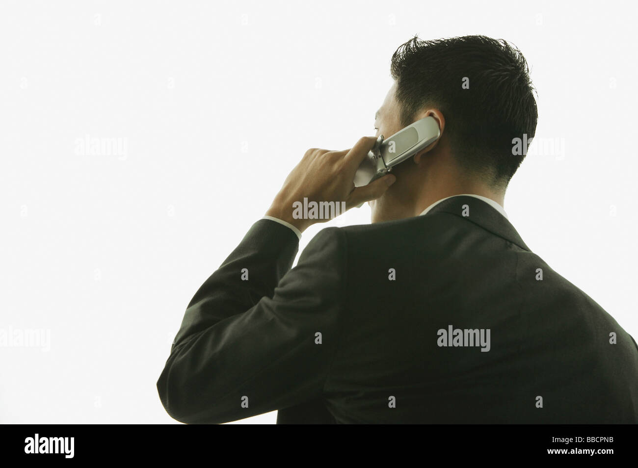 Young man, rear view, on the phone Stock Photo - Alamy