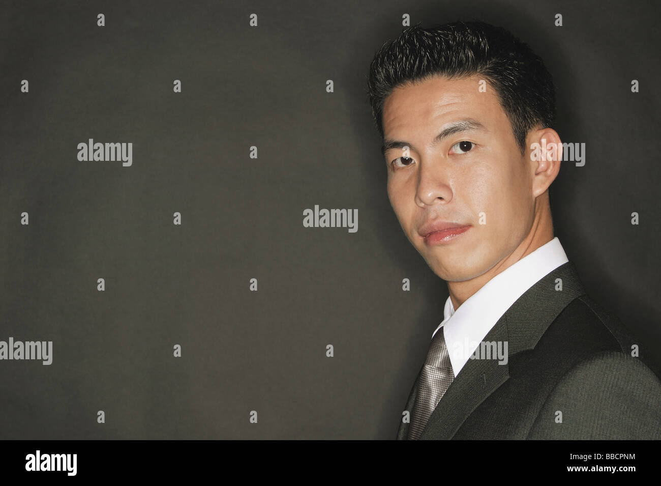 Young man looking at camera, side view Stock Photo - Alamy