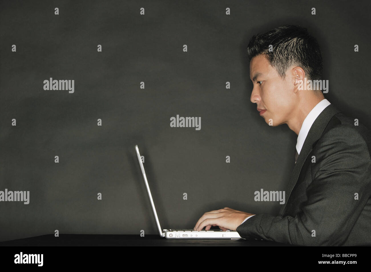Young man using laptop, side view Stock Photo - Alamy