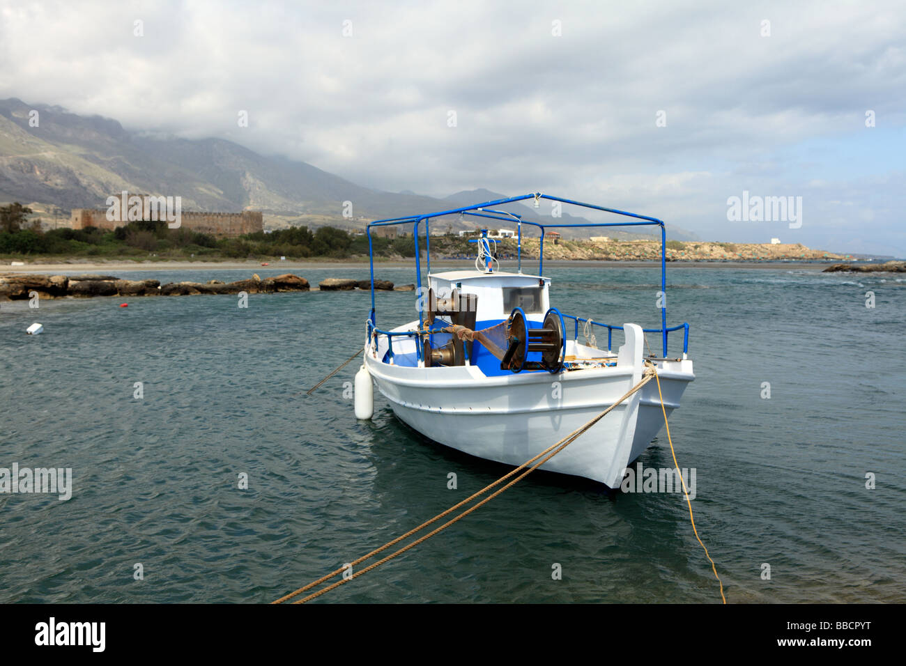A greek fishing caique moored off the south coast of Crete with ...