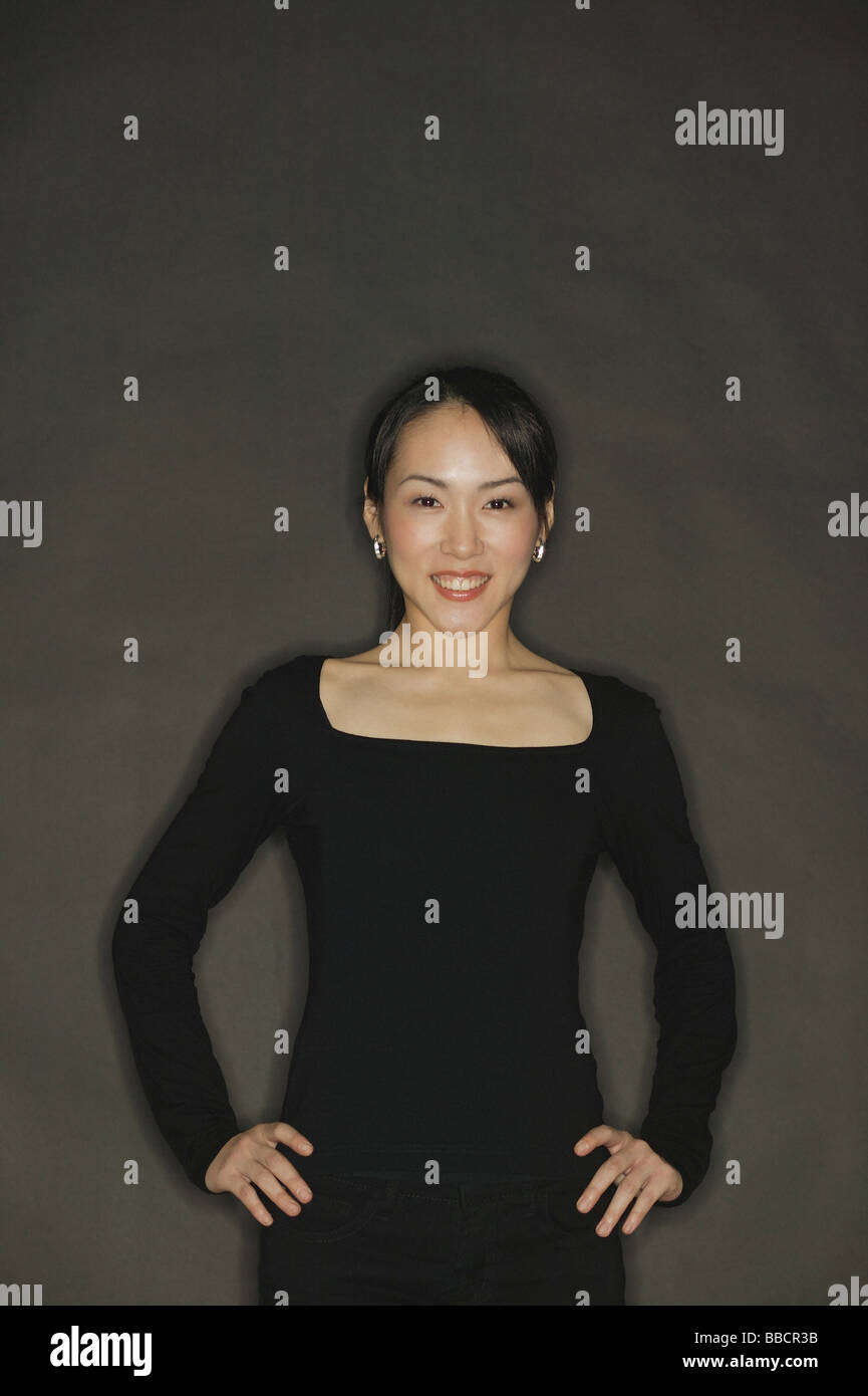 Young woman, smiling, black background Stock Photo - Alamy