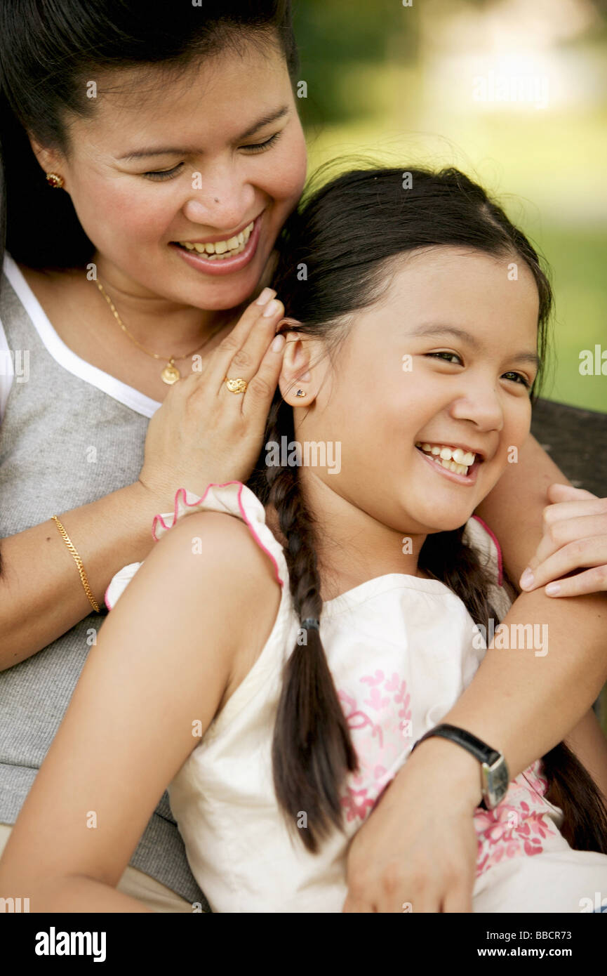 Mother hugging daughter, laughing Stock Photo - Alamy