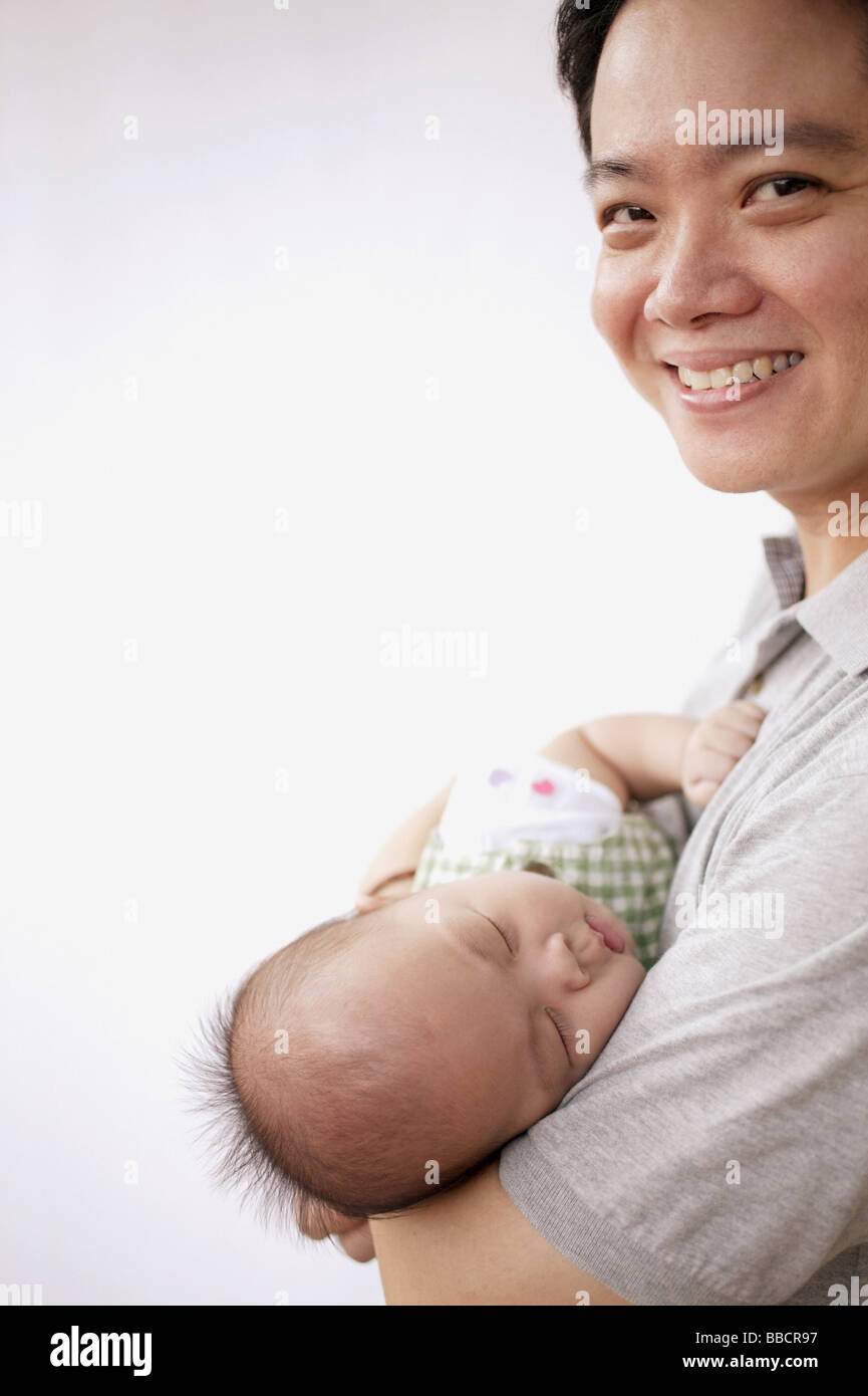 Father carrying baby Stock Photo - Alamy