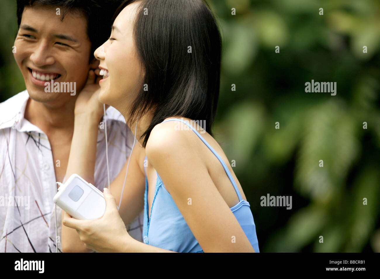 Couple listening to MP3 player Stock Photo - Alamy