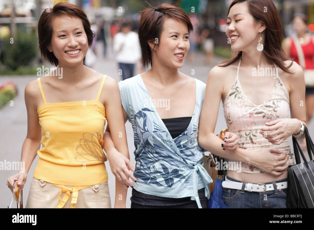 Friends walking side by side, talking Stock Photo - Alamy