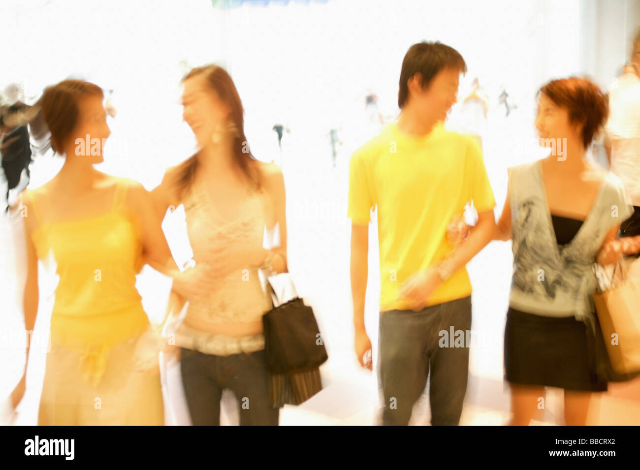 Friends walking side by side, talking Stock Photo - Alamy