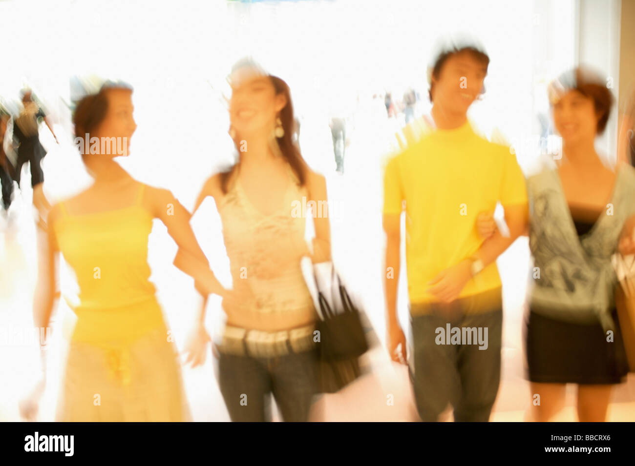 Friends walking side by side, arm in arm Stock Photo - Alamy