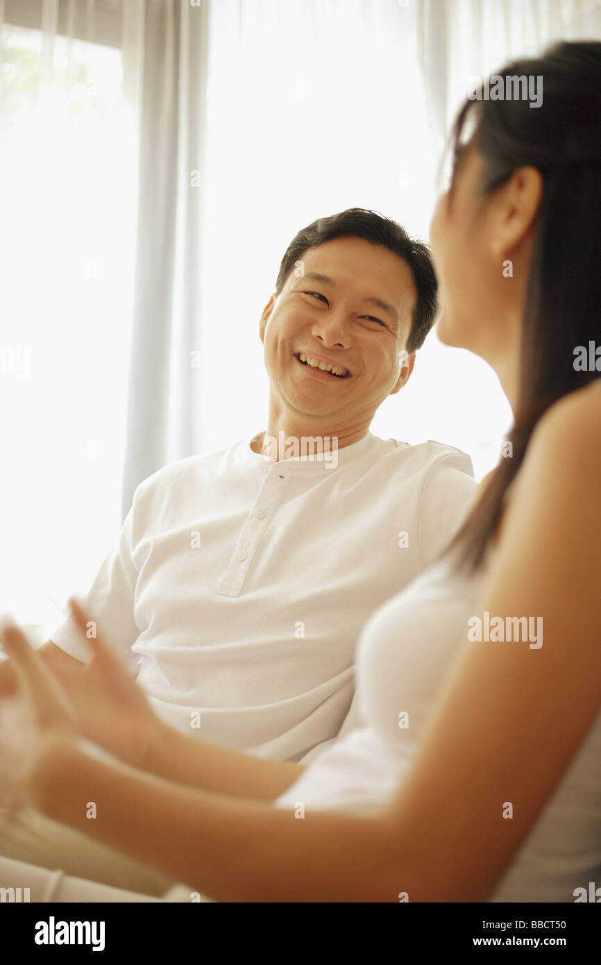 Couple sitting down side by side, talking Stock Photo - Alamy