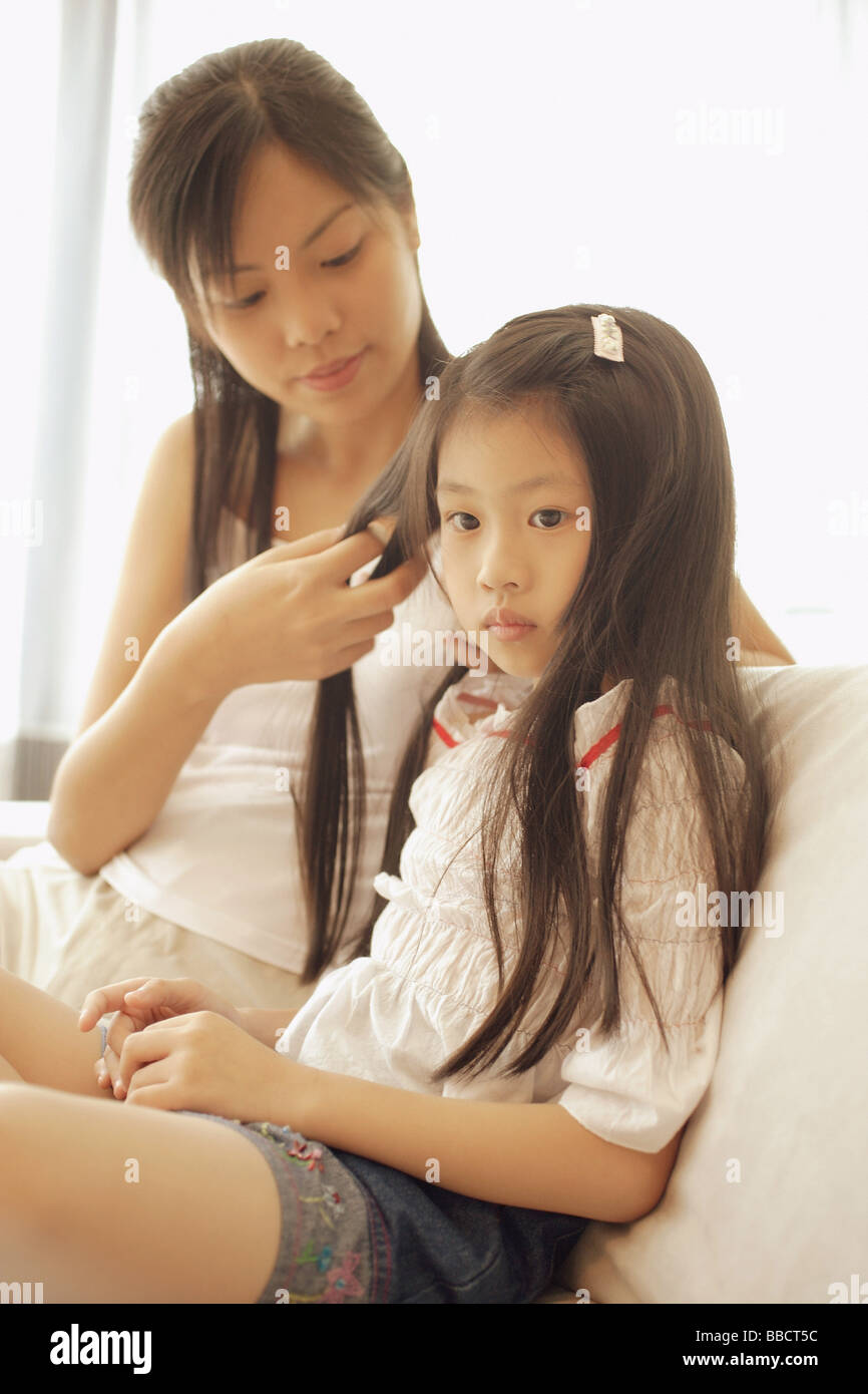 Mother braiding daughters hair hi-res stock photography and images - Alamy