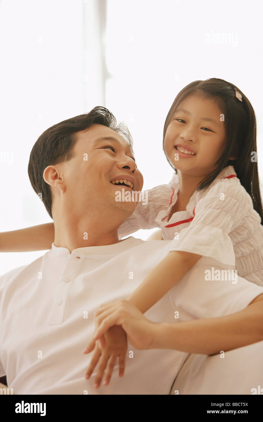 Daughter hugging father from behind Stock Photo - Alamy