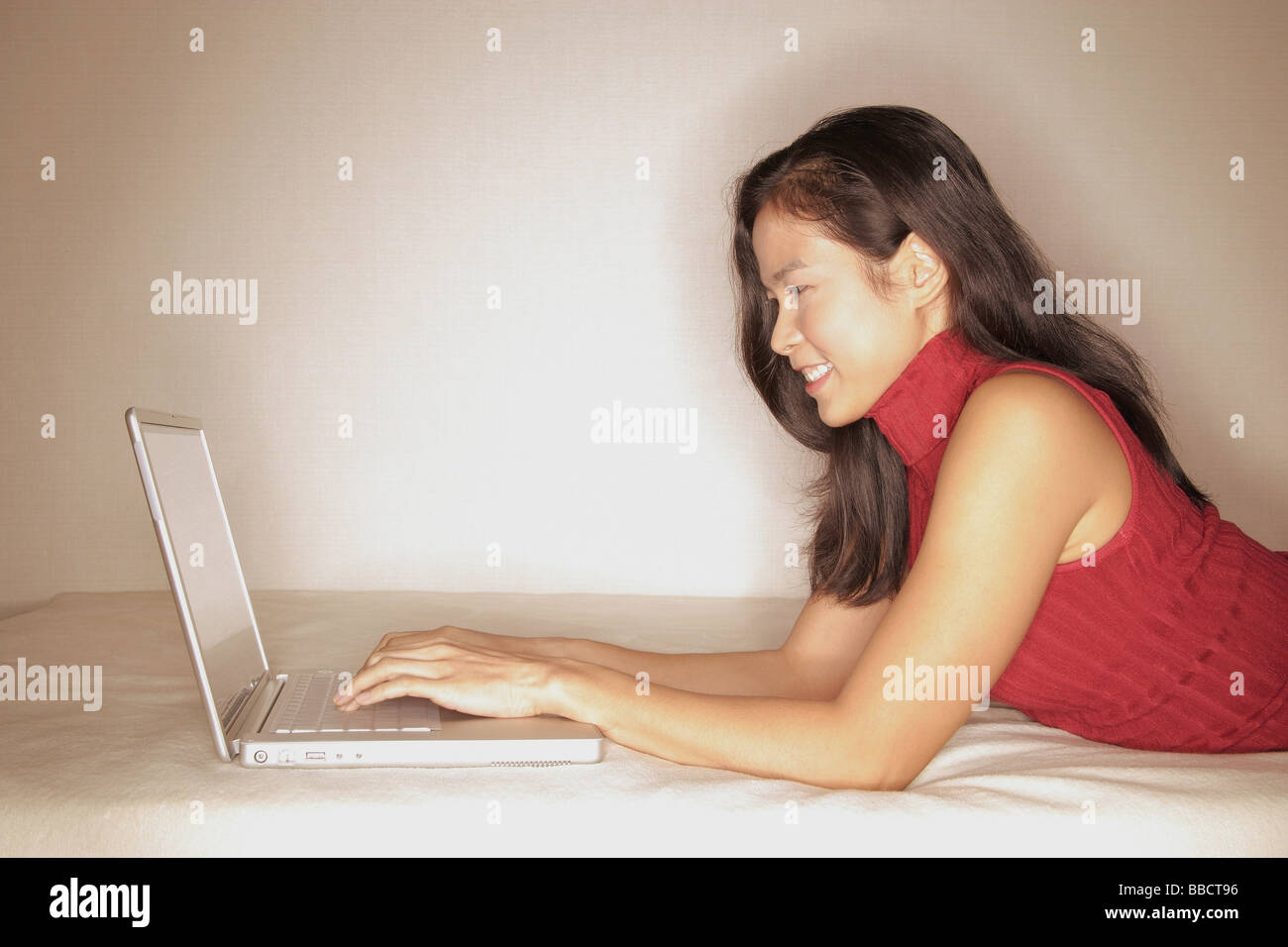 Woman using laptop, profile Stock Photo - Alamy
