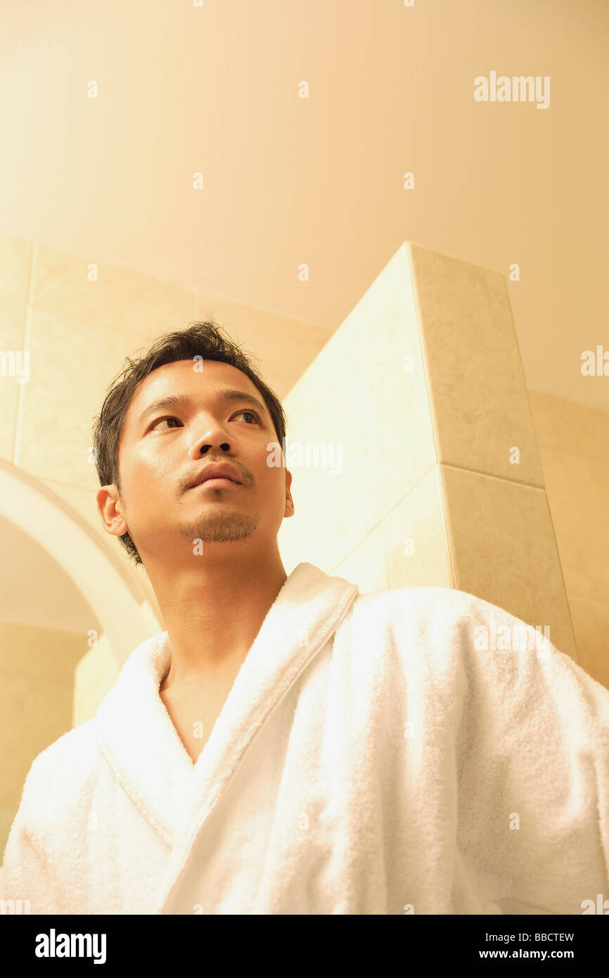 Young man in robe looking away Stock Photo - Alamy