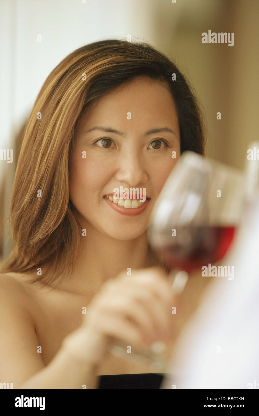 Woman raising wine glass, toasting Stock Photo - Alamy