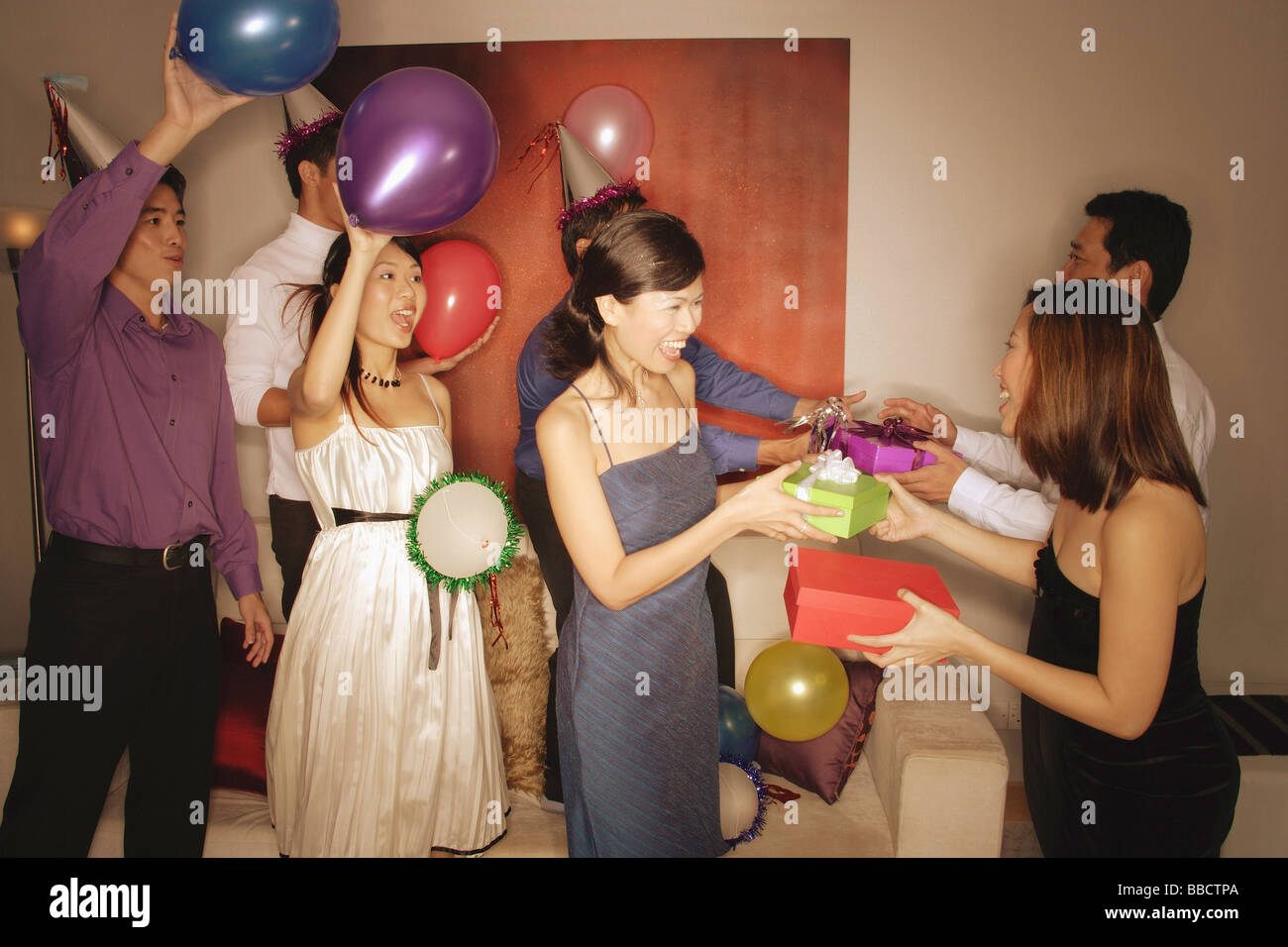 Group of friends exchanging gifts Stock Photo - Alamy
